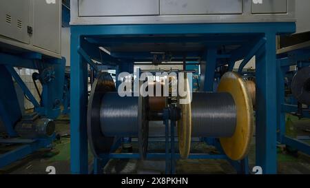 Rotating coils in industrial enterprise. Creative. Process of plastic ...