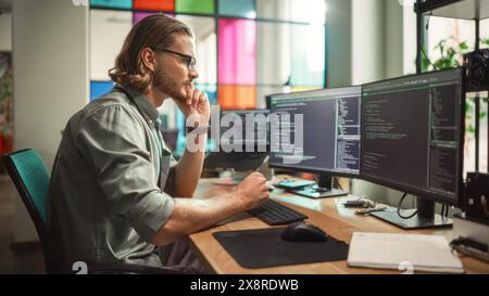 Two computer monitors set up on a desk in a modern office environment ...