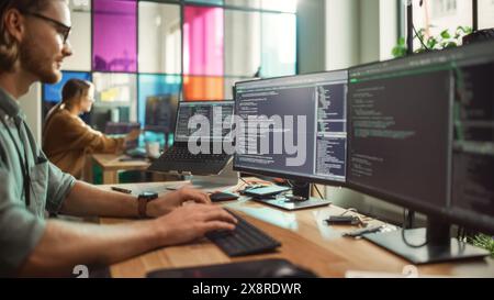 Two computer monitors set up on a desk in a modern office environment ...