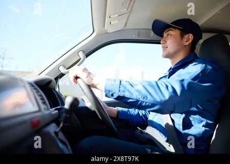 Japanese delivery man sitting in the driver seat of a car Stock Photo ...