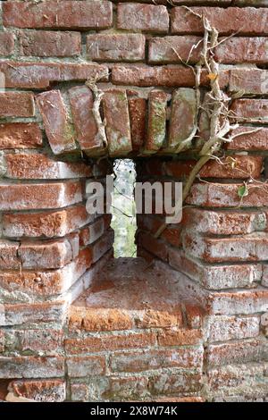 vertical slit on a wall in a construction with some light coming in ...