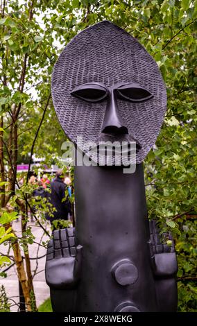 Tribal inspired statue among the leaves Stock Photo - Alamy