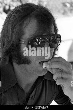 Brazilian car racer Emerson Fittipaldi (with sunglasses) takes his ...