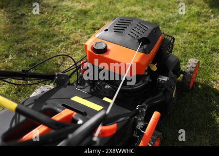 Modern lawn mower on green grass Stock Photo - Alamy