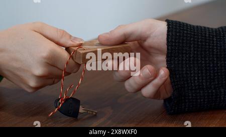 Passing small key with wooden number of a locker. Media. Close up of ...