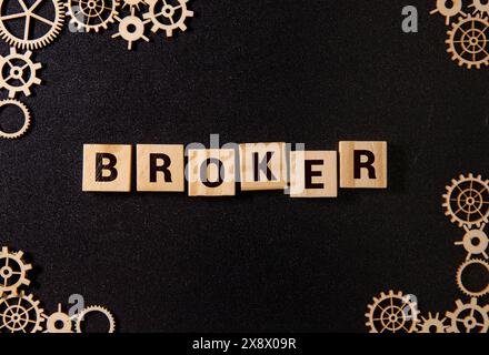 broker word written on wood block. broker text on wooden table for your ...
