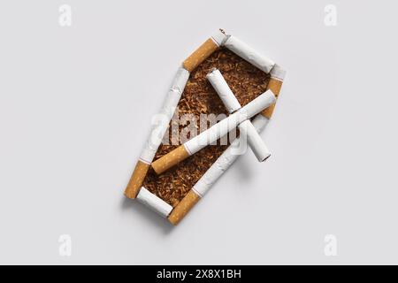 Coffin made of cigarettes and tobacco on white background. Stop smoking ...