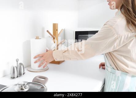 Housewife taking roll of paper towels from drawer in kitchen, closeup ...