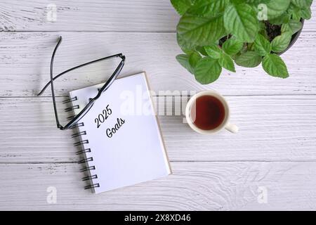 2025 goals on notepad. Top view. New year goals, plan and action ...