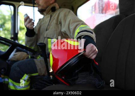 Firefighter using portable radio set while driving fire truck Stock ...