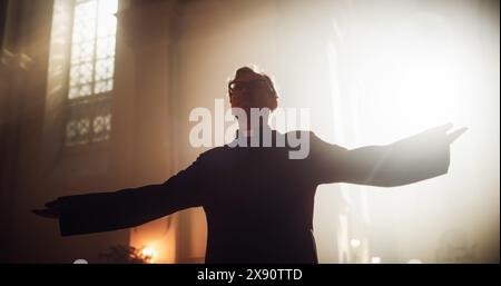 Portrait of Christian Priest Raising Hands In Blessing His Congregation ...