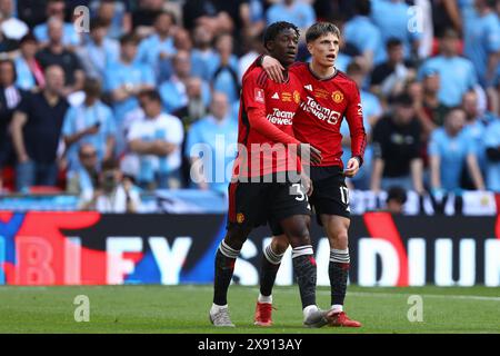 Kobbie Mainoo of Manchester United is congratulated by Christian ...
