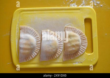 Preparation of fresh homemade pasta mezzaluna with ricotta Stock Photo ...