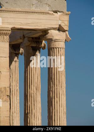 Close-up of ancient doric columns under a clear blue sky, ancient columns in front of a blue sky ...