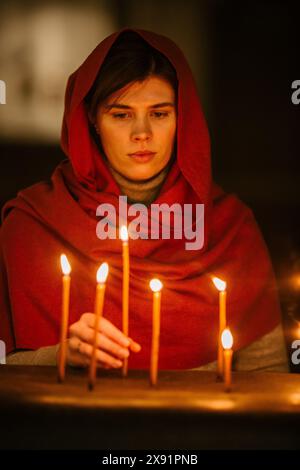 Aesthetic Shot of Young Christian Woman Lighting a Candle in Church ...