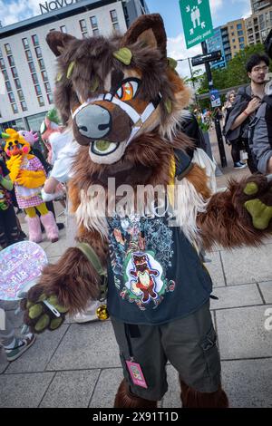 A visitor to the second day of Comic Con London Poses outside the venue ...