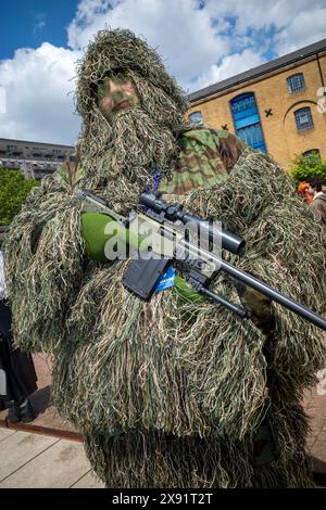 A green military sniper rifle with a scope for long distance tactical ...