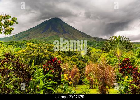 View over the Arenal Volcano at dusk on a stormy day, La Fortuna ...