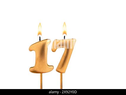 Golden number 17 birthday candle on white background Stock Photo - Alamy