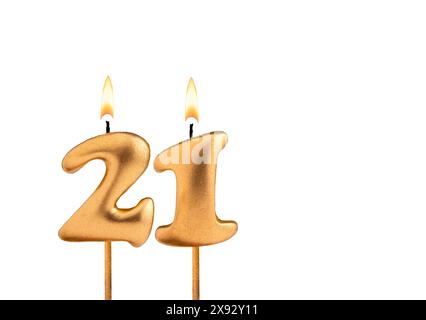 Number 21 gold celebration candle on star and glitter blue background ...