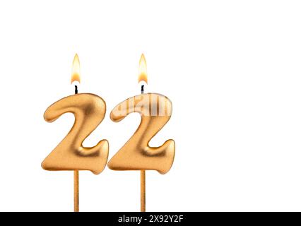 Golden number 22 birthday candle on white background Stock Photo - Alamy