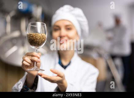 Woman brewer holding glass of malt seeds Stock Photo - Alamy