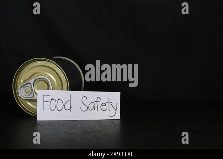 Food safety concept. Labeled canned food in dark black background Stock ...