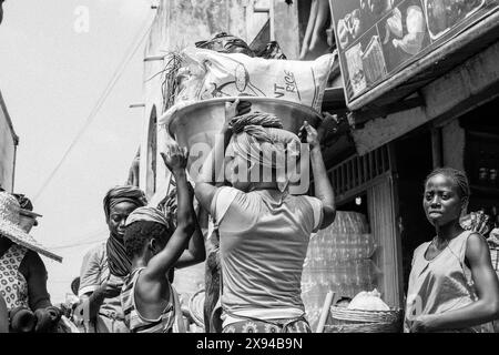 the African women carrying heavy loads sometimes on their heads over ...