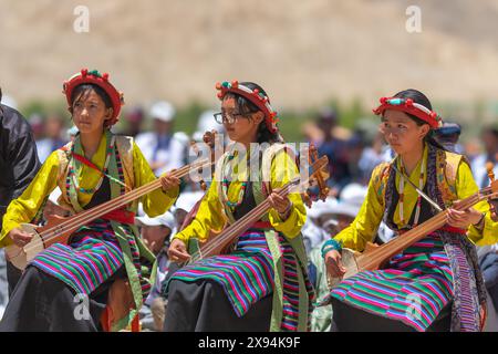 Portrait of young Ladakhi girls wearing traditional attire and playing ...