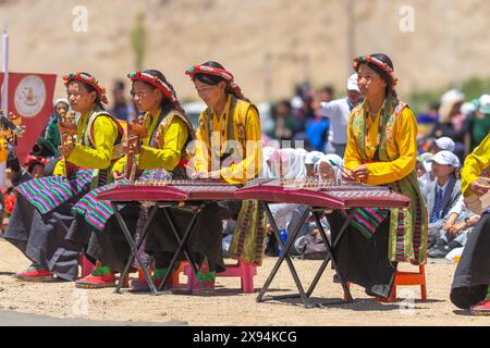 Portrait of young Ladakhi girls wearing traditional attire and playing ...