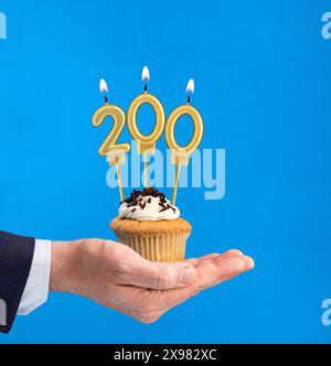 birthday cake with number 200 - cupcake on orange background with ...