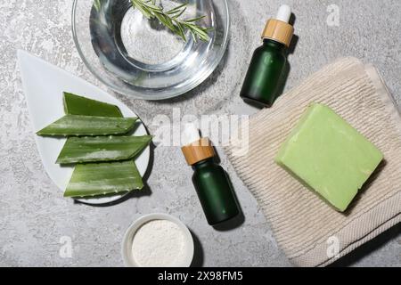 Many bottles of aloe vera essential oil on white background. Pattern ...
