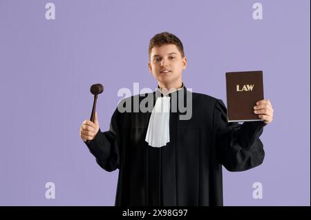 Teenage judge with law book and gavel on lilac background Stock Photo ...