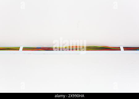 Exposed colourful cables on electrical wire casing holder base for ...