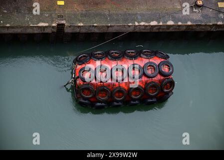 A marine fender beside the harbour wall at the Queen Elizabeth II ...