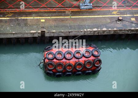 A marine fender beside the harbour wall at the Queen Elizabeth II ...