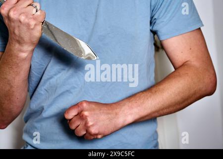 30 May 2024: Symbolic image of domestic violence. An angry man holds a ...
