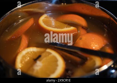 Spiced Apple Cider simmering on the stove Stock Photo - Alamy