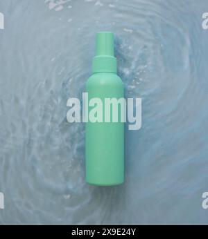 A glass tube with cosmetic oil and a tube of hand cream on a wooden ...