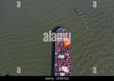 Devotees crowd the rooftops of vessels as they journey to attend the ...