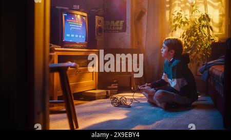 Young Boy Playing Eighties 2D Arcade Space Shooter Game on a Gaming ...