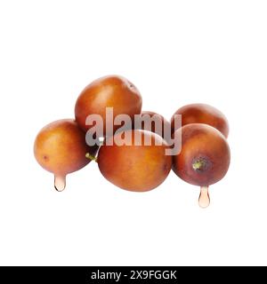 Oil dripping from palm fruits on white background Stock Photo - Alamy