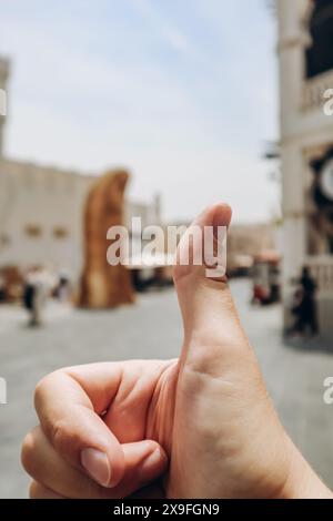 The Golden Thumb Statue, Souq Waqif, Doha, Qatar, with the Fanar Qatar ...