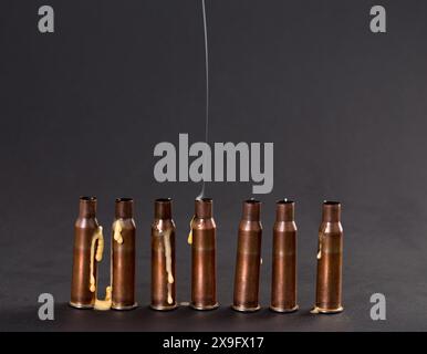 Empty rifle casing with smoke on a black background Stock Photo - Alamy