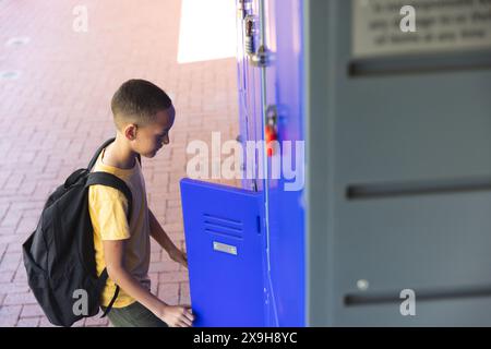 Biracial boy at school locker, with copy space Stock Photo - Alamy
