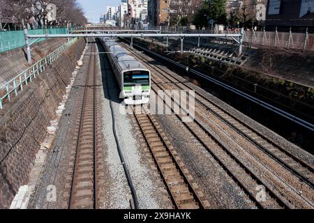 An E231-500 series train on the JR Yamanote line in front of the ...