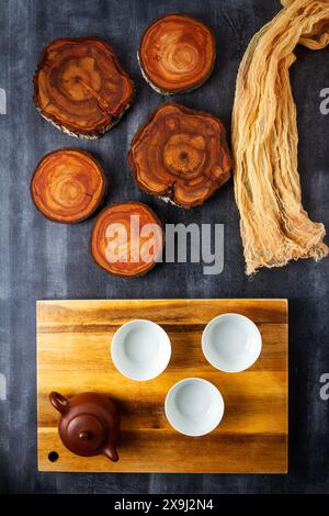 A top view of a teapot and cups on a wooden board Stock Photo - Alamy