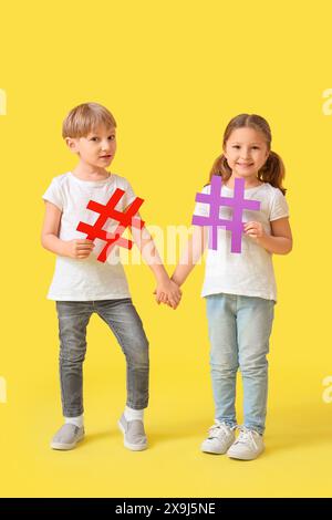 Cute little girl with hashtags on grey background Stock Photo - Alamy