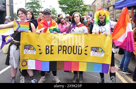 Participants carry the Bury Pride banner at the front of the parade ...