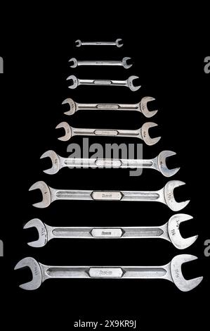 Steel open-end wrenches and flat spanners on metallic background ...